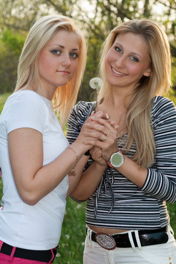 Two smiling young blonde stock image. Image of friendship - 23118957