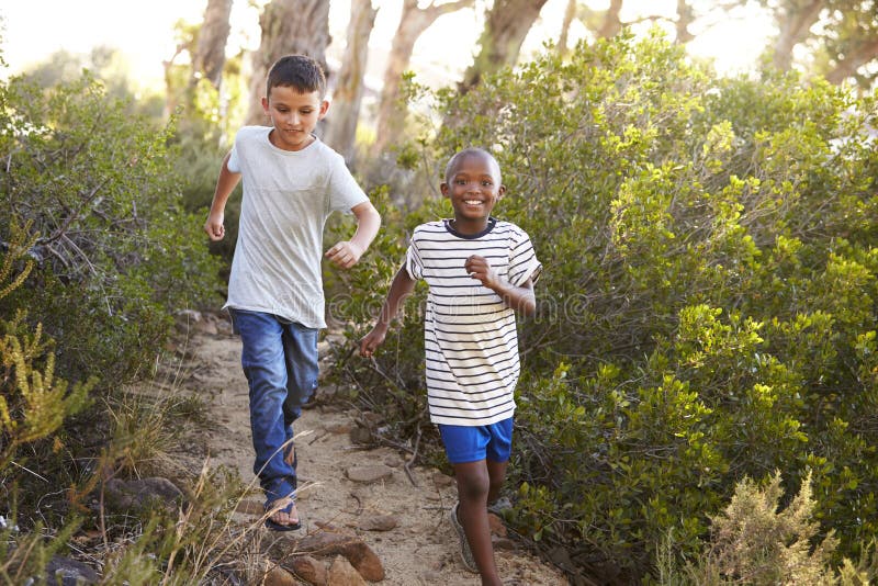 Two Smiling Young Boys Racing on a Forest Path Stock Image - Image of ...