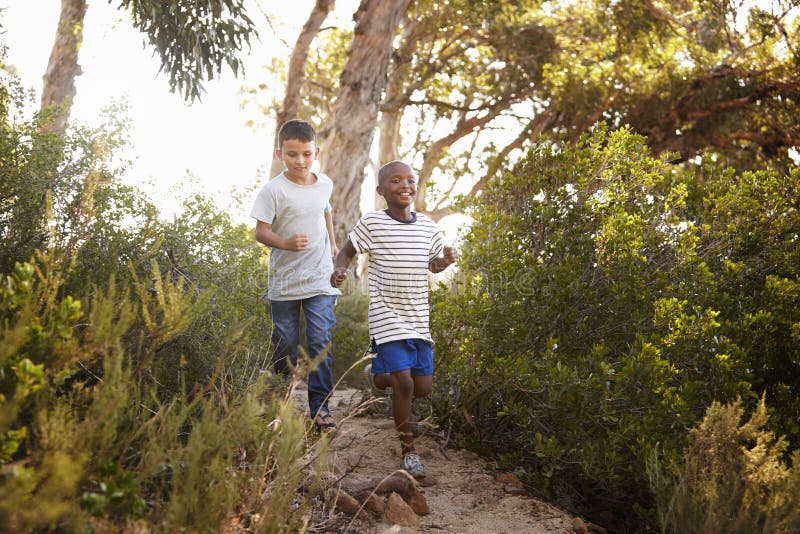 Two Smiling Young Boys Running Down a Forest Path Stock Photo - Image ...