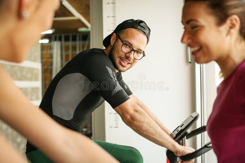 Two Smiling Young People Exercise in Gym. Stock Image - Image of ...