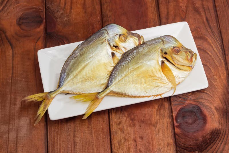 Two Smoked Atlantic Moonfish on Dish on Rustic Table Stock Photo ...