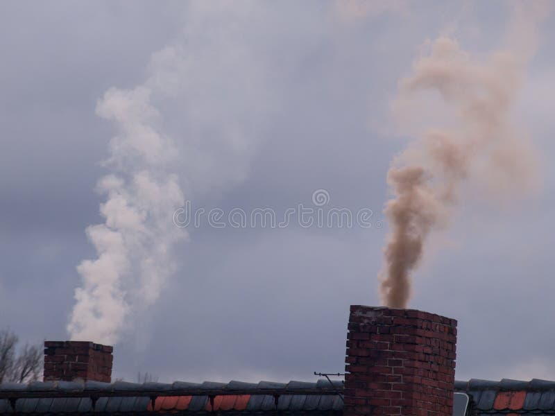 Two smoking chimneys stock photo. Image of background - 215080290
