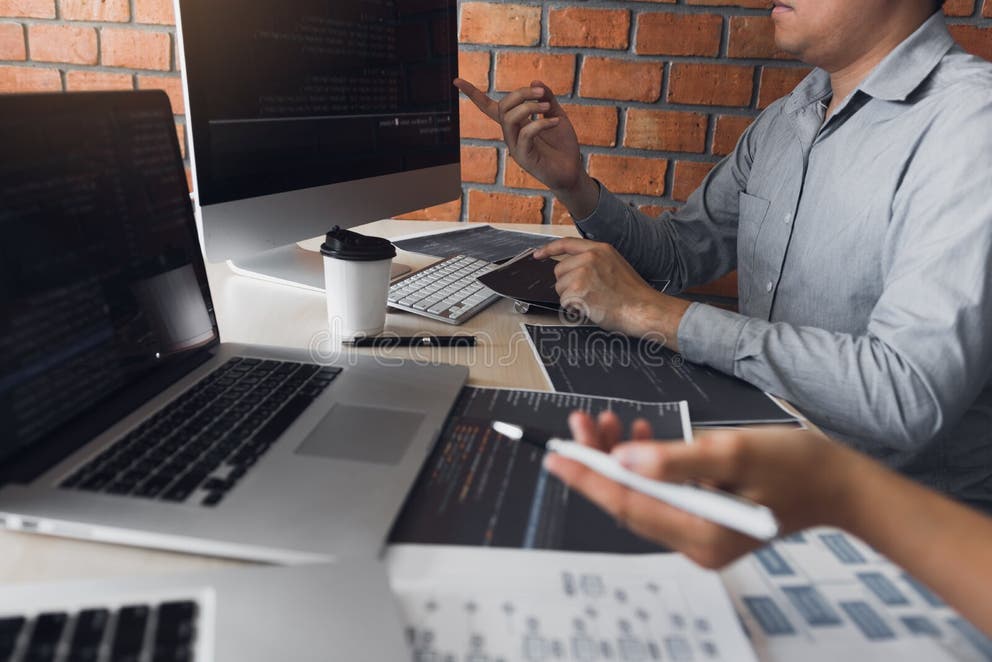 Two Software Developers are Analyzing Together about the Code Written ...