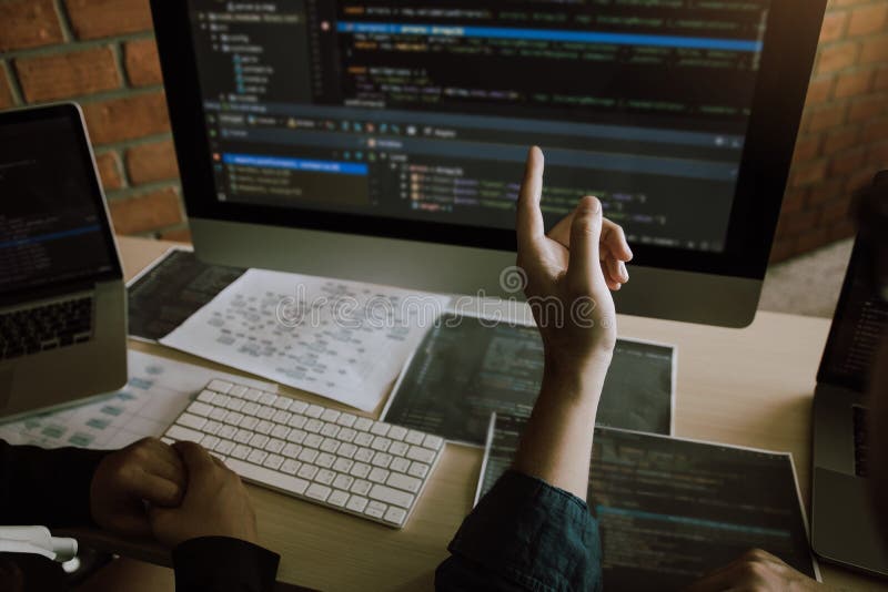 Two Software Developers Are Analyzing Together About The Code Written Into The Program On The