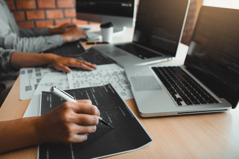 Two Software Developers are Using Computers To Work Together with Their ...
