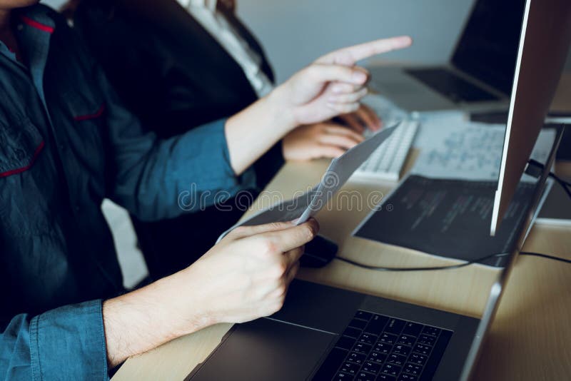 Two Software Developers are Using Computers To Work Together with Their ...