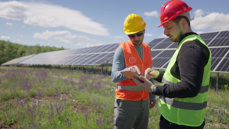 Two Solar Project Managers Discussing about Solar Panels Using Tablet ...