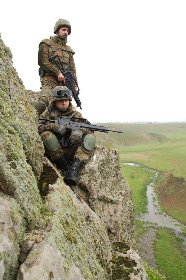 Two soldiers on the cliff stock photo. Image of mountains - 20786078