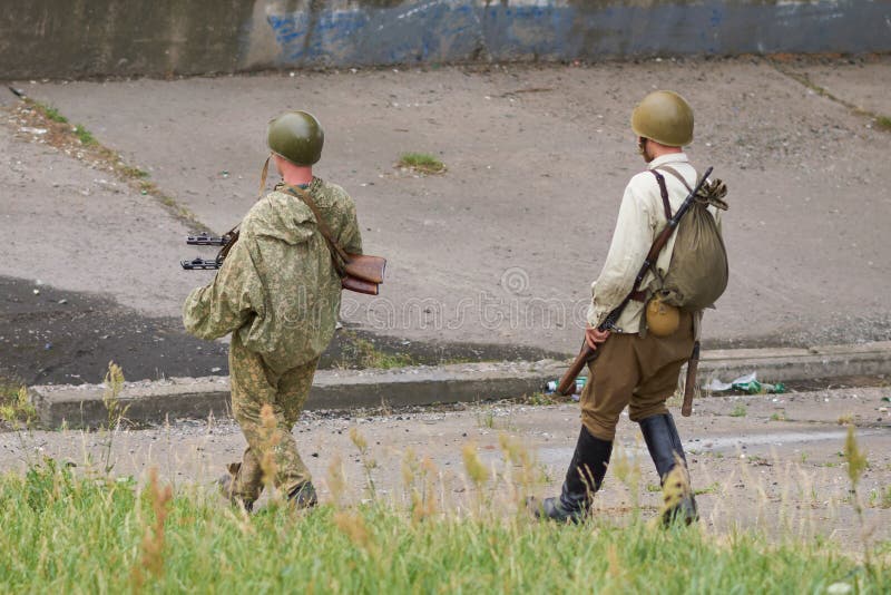 Two Soldiers in Soviet Uniforms, with Assault Rifles, from the Back ...