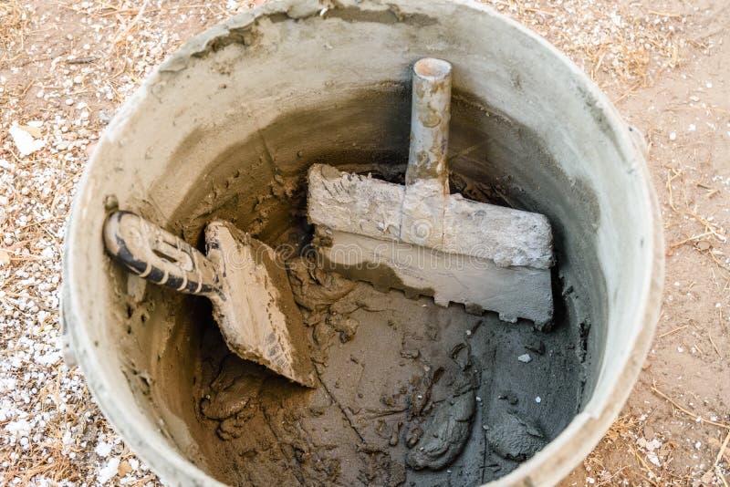 Two Spatulas in Bucket with the Mortar Stock Photo - Image of industry ...