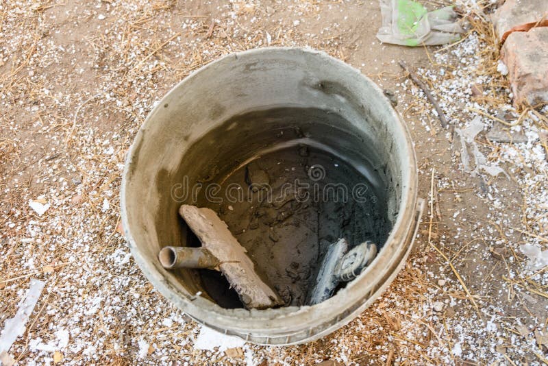Two Spatulas in Bucket with the Mortar Stock Image - Image of ...