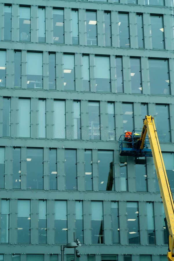 Two Specialist Technicians Check and Repair the Facade of the Building ...