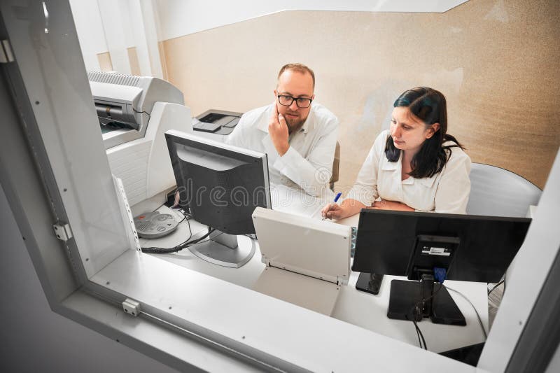 Two Specialists Sitting at Computer, Working in Hospital. Stock Image ...