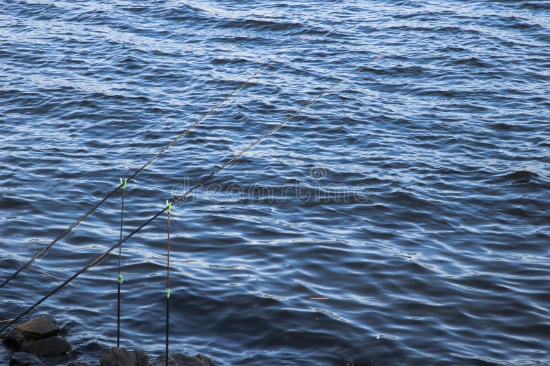 Two Spinning Rods Standing on Pods Near the River Water Stock Photo ...