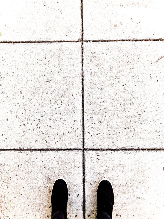 Two Steps Ahead on the Sidewalk Stock Photo - Image of cement, standing ...