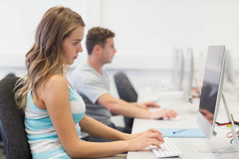 Two Stern Students Working on Computer Individually Stock Image - Image ...