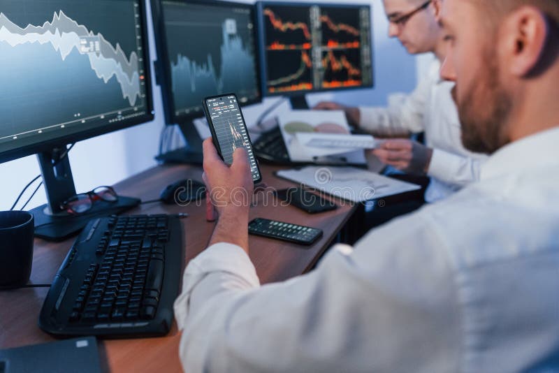 Two Stock Traders Working in the Office with Exchange Technology Stock ...