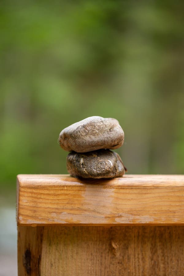 Two Stones on Top of Each Other on a Wooden Bridge Stock Photo - Image ...