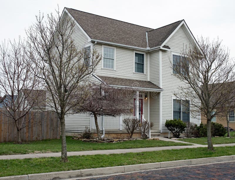 Two Story Tan House in Early Spring Stock Image - Image of shrub ...