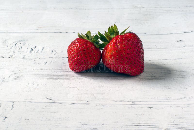 Two Strawberries Basking in the Natural Light Stock Photo - Image of ...