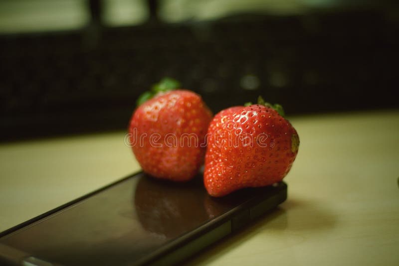 Two Strawberry on mobile stock photo. Image of mobile - 87770028