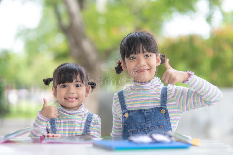 Two Student Little Asian Girls Reading the Book on Table Stock Photo ...