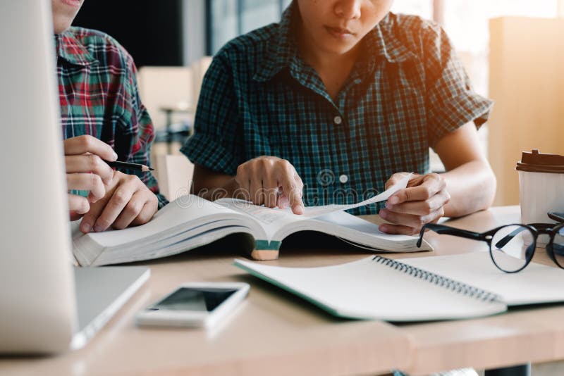 Two Student Reading Textbook for Test Together in Library. Stock Photo ...