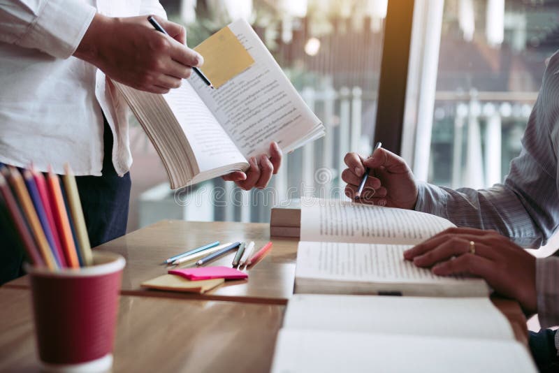 Two Student Reading Textbook for Test Together in Library Stock Photo ...