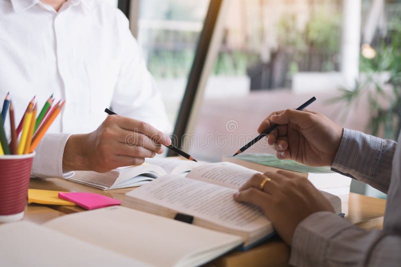 Two Student Reading Textbook for Test Together in Library Stock Photo ...