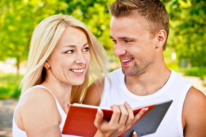 Two students with book stock photo. Image of female, park - 14474642