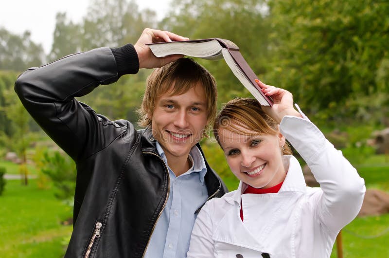 Two students with book stock photo. Image of notebook - 26516890