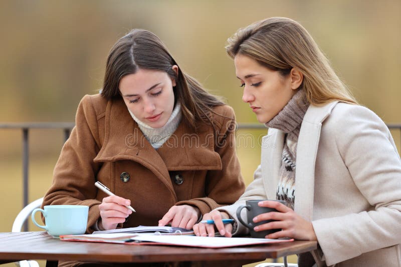 Two Students Checking Notes in a Terrace Stock Photo - Image of ...