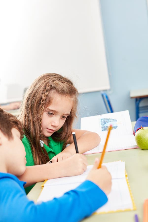 Two students write a test stock image. Image of young - 136063627