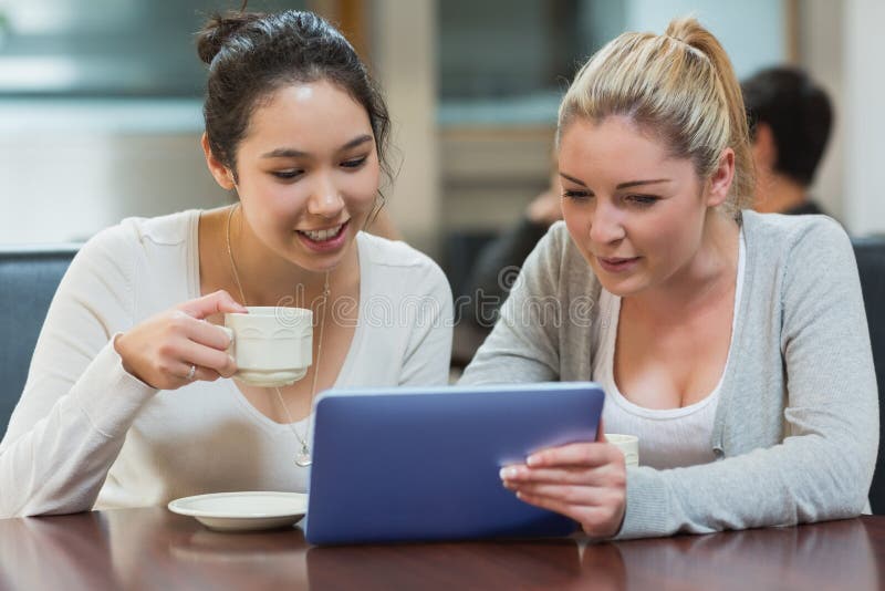 Two Students in a Coffee Shop Using a Tablet Pc Stock Image - Image of ...