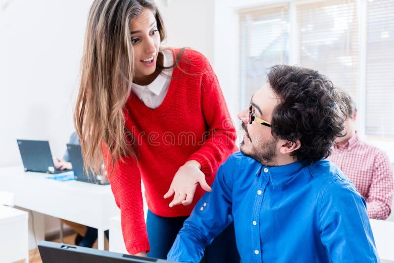 Two Students Discussing Their Work in College Stock Photo - Image of ...