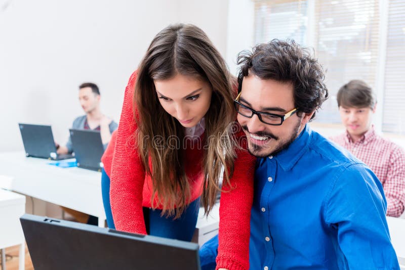 Two Students Discussing Their Work in College Stock Photo - Image of ...