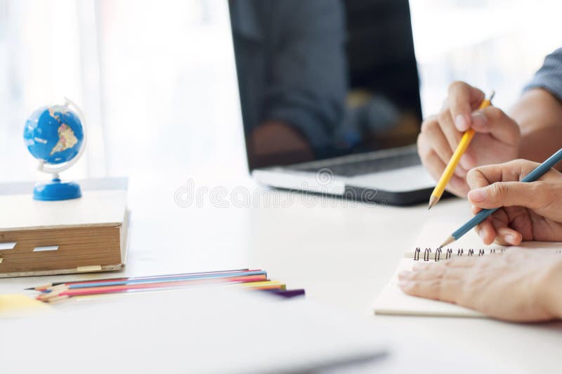 Two Students Doing Homework Together and Helping Each Other Sitting in ...