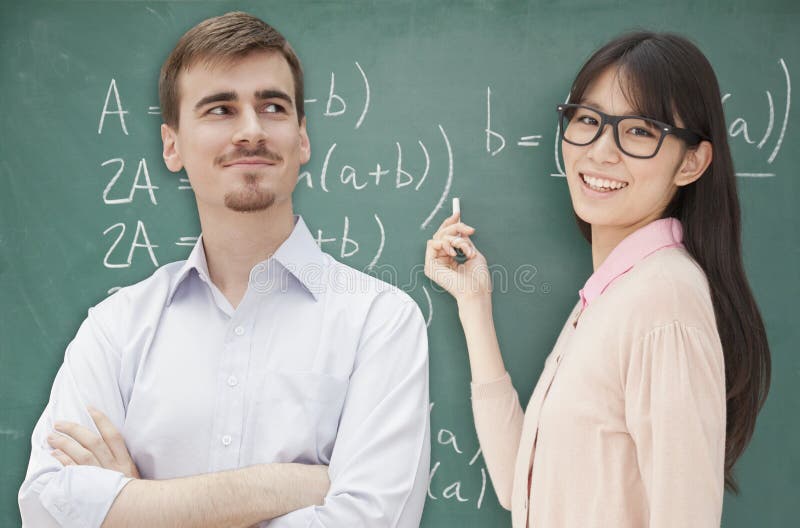 Two Students Doing Math Formula on the Chalkboard, Beijing Stock Photo ...