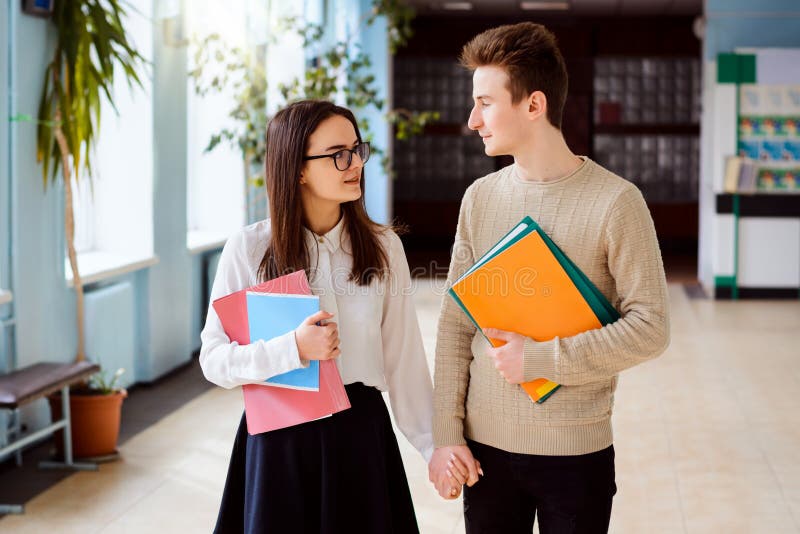 Two Students Going in the Corridor of University Building after Classes ...
