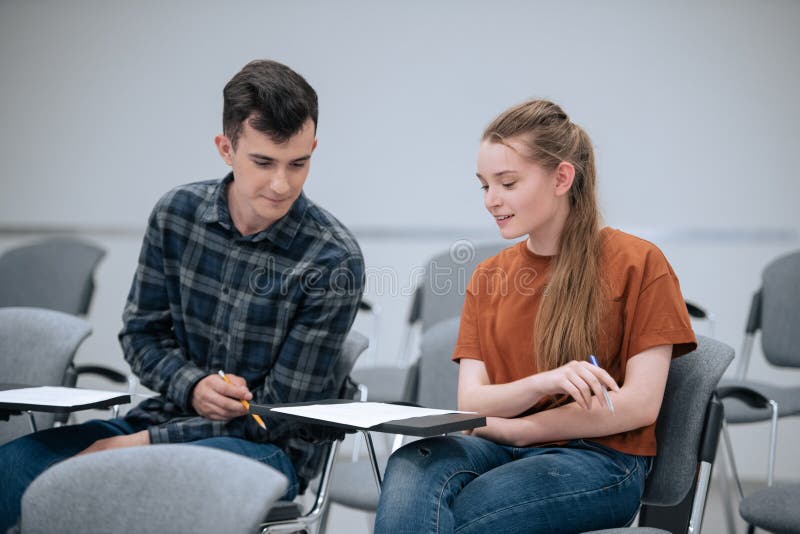 Two Students a Guy and a Girl Sit Next To Each Other at a Lecture in ...
