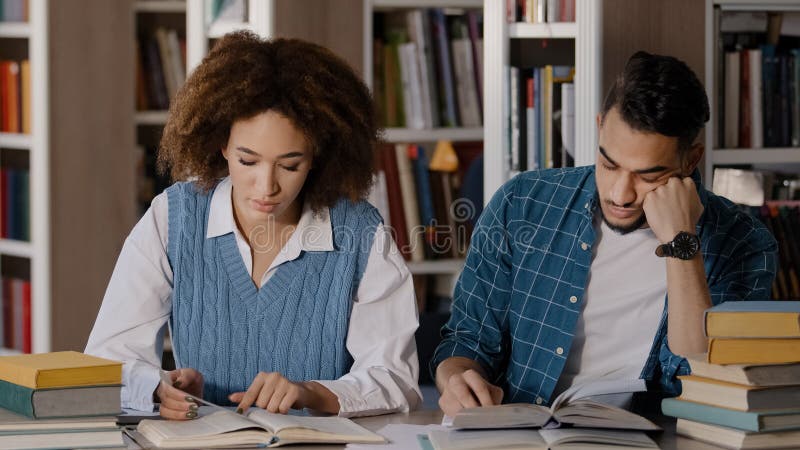 Two Students Guy and Girl Sitting at Desk Classroom Writes Notes in ...