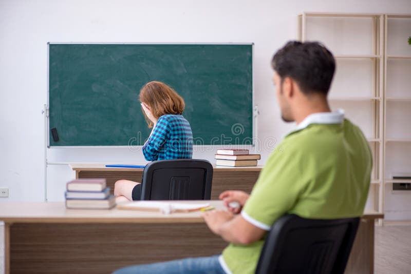 Two Students Having Fun in the Classroom Stock Image - Image of back ...
