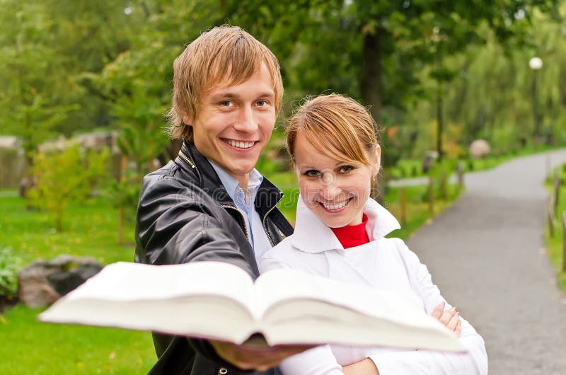 Two Students with Open Book Stock Image - Image of campus, education ...