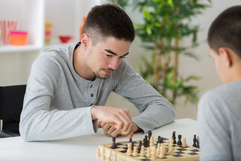 Two students playing chess stock photo. Image of skin - 121232056
