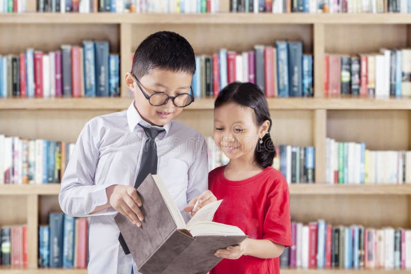 Two Students Reading Book in Library Stock Image - Image of concept ...
