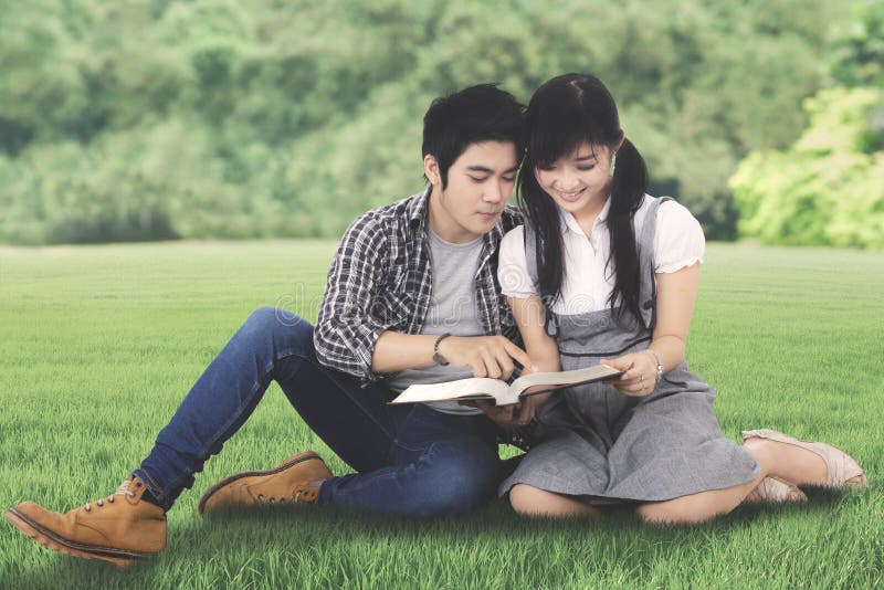 Two Students Reading a Book in the Park Stock Image - Image of ...