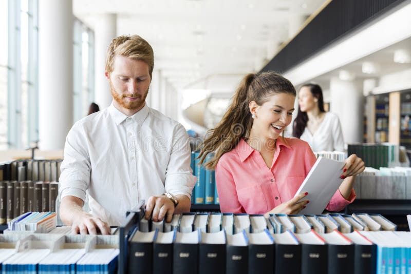 Two Students Reading and Studying in Library Stock Photo - Image of ...