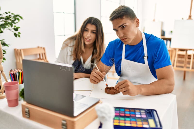 Two Students with Serious Expression Having Artistic Online Class Using ...