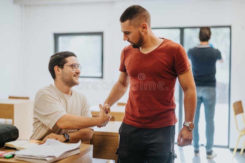 Two Students Shaking Hands in a Bright Classroom Setting Stock Photo ...