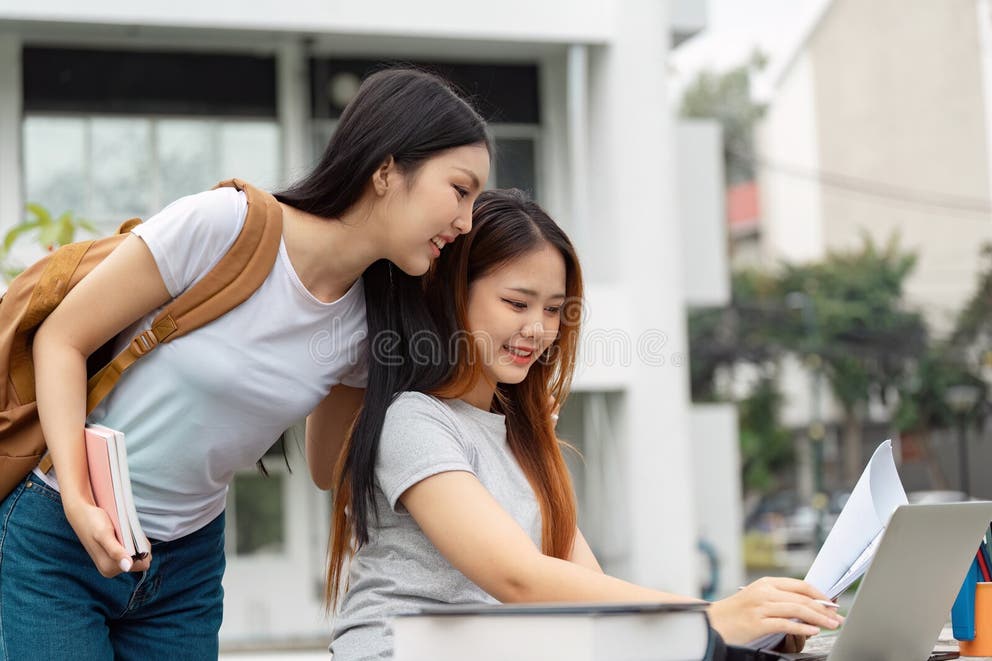 Students Collaborating with a Laptop and Books in an Engaging Outdoor Study Session Stock Image ...